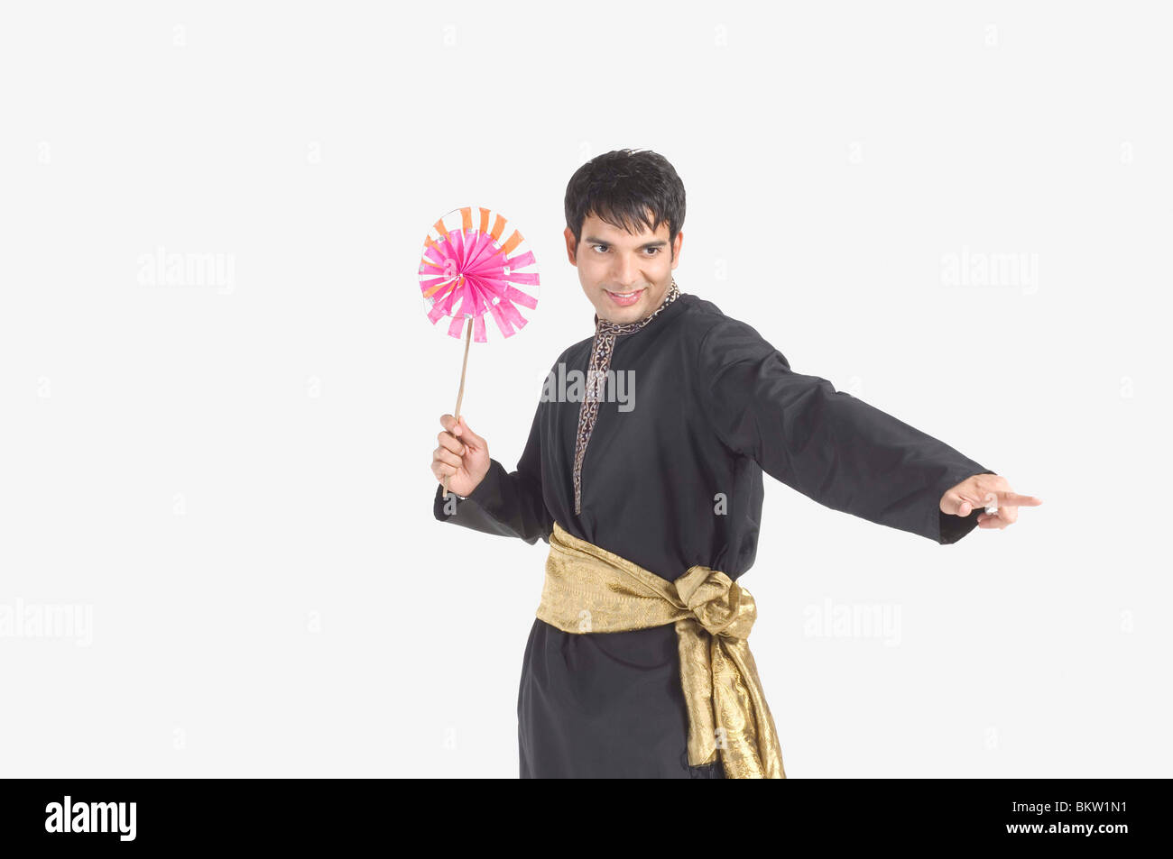 Young man holding pinwheel Stock Photo - Alamy