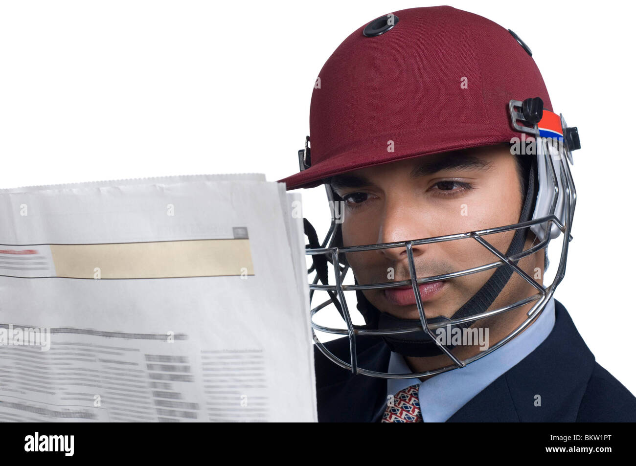 Businessman wearing sports helmet, reading newspaper, close-up Stock ...