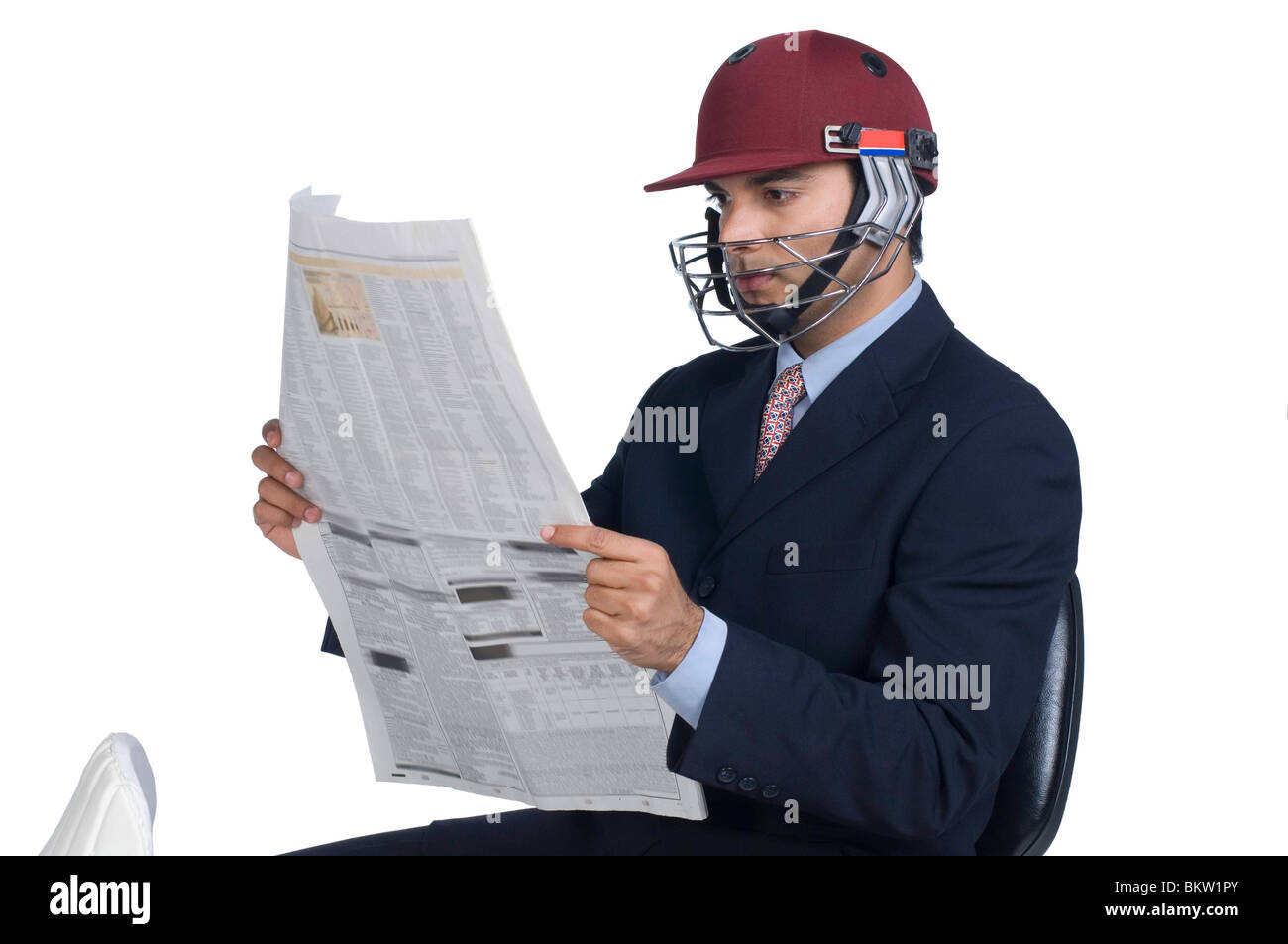 Businessman wearing sports helmet, reading newspaper, close-up Stock ...