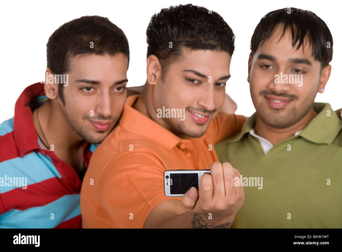 Friends photographing with mobile phone, smiling Stock Photo - Alamy