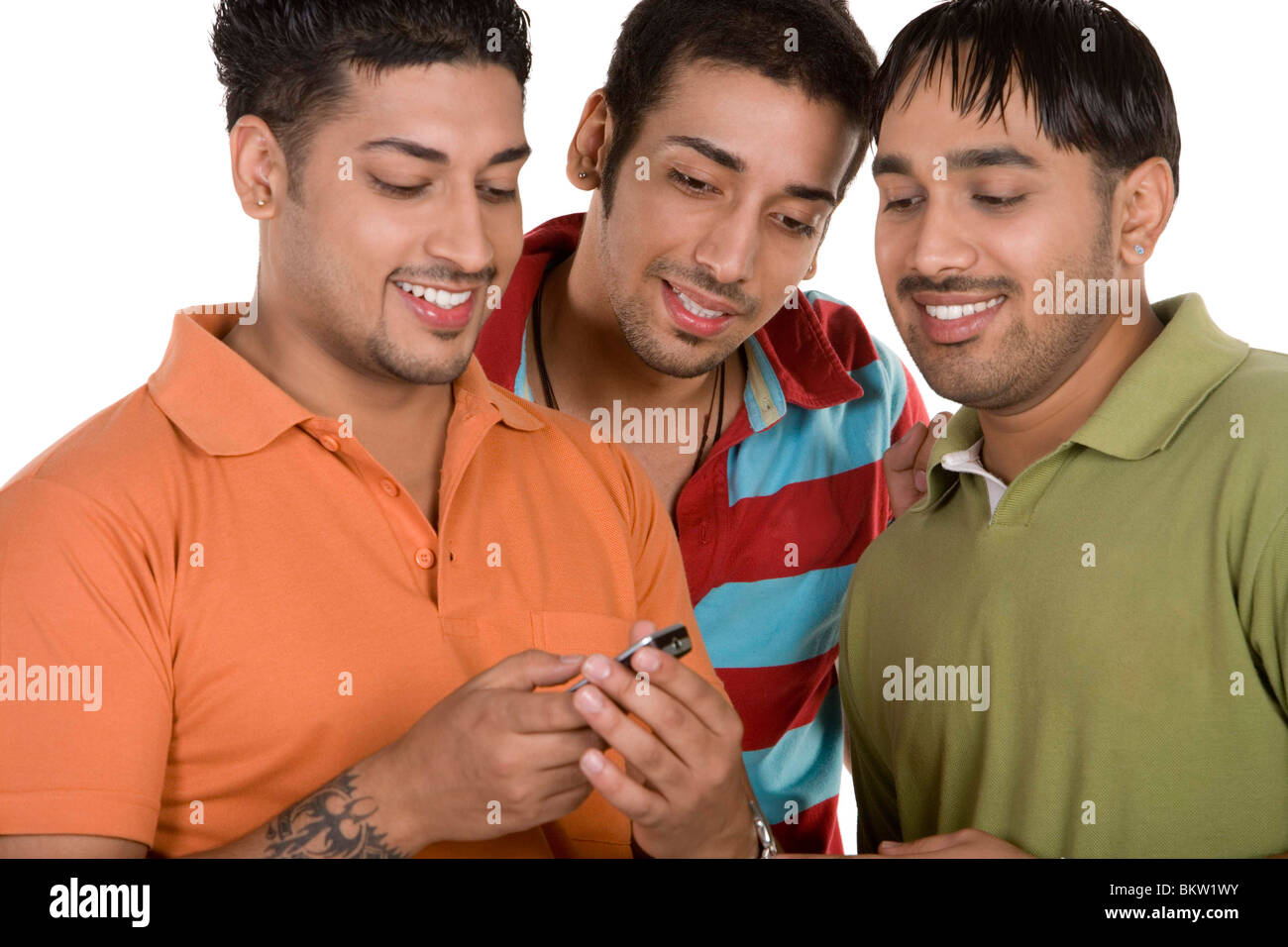 Friends reading text message, smiling Stock Photo - Alamy