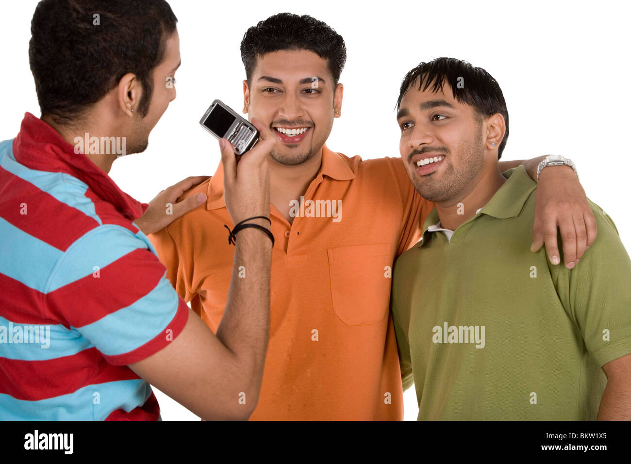 Man taking photograph of friend, smiling Stock Photo - Alamy