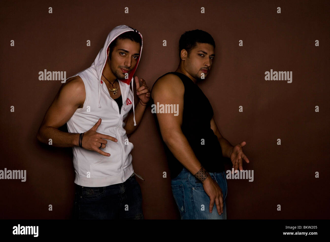Friends posing against colored background, portrait Stock Photo - Alamy