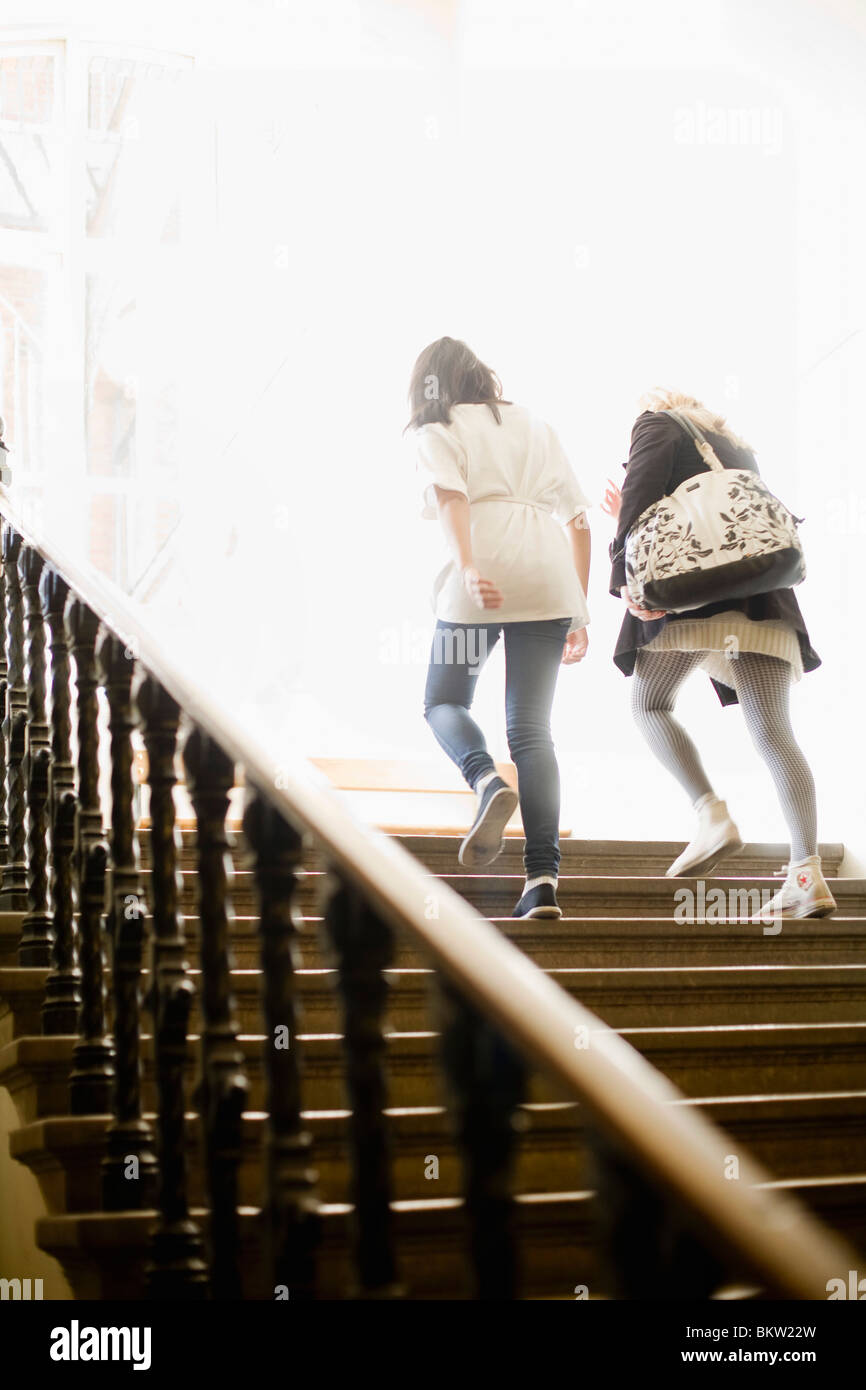 Two girls in stairs Stock Photo - Alamy