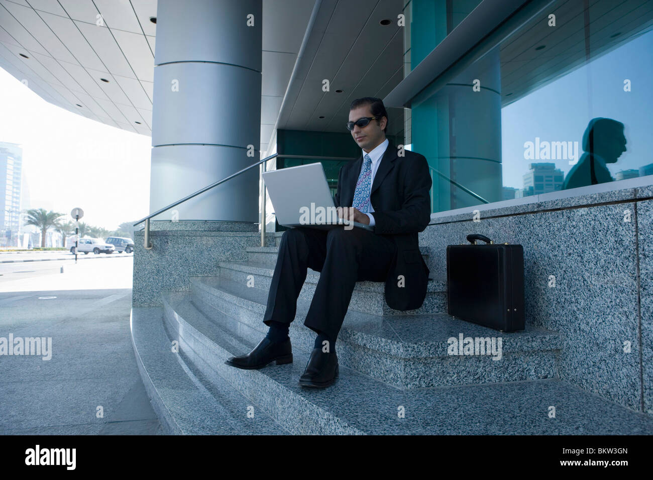 Businessman using laptop, side view Stock Photo - Alamy