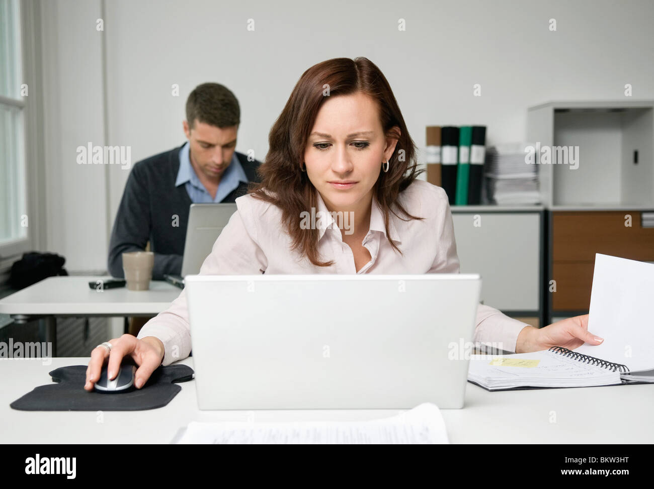 Concentrated coworker at office Stock Photo - Alamy