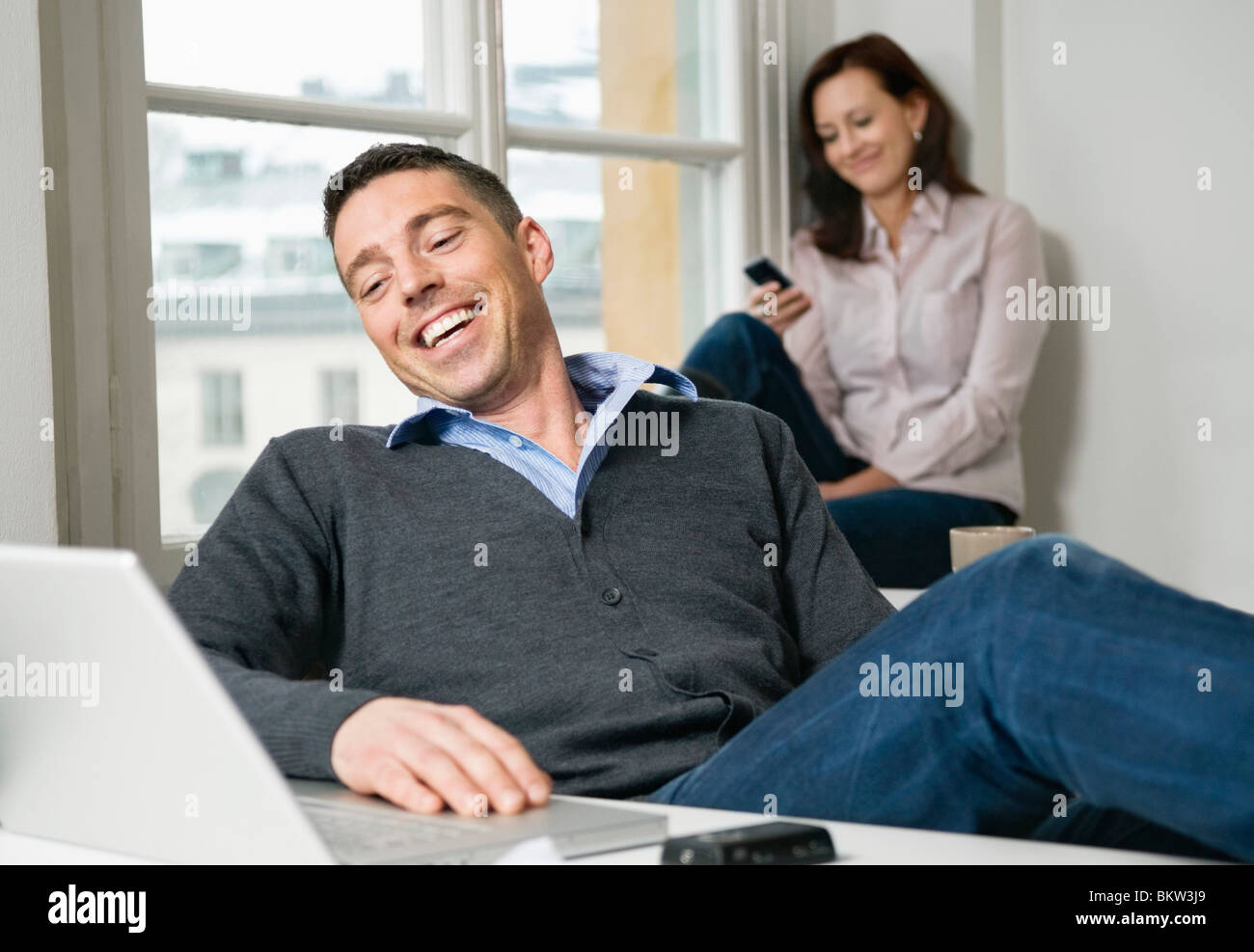 Laidback coworkers at office Stock Photo - Alamy