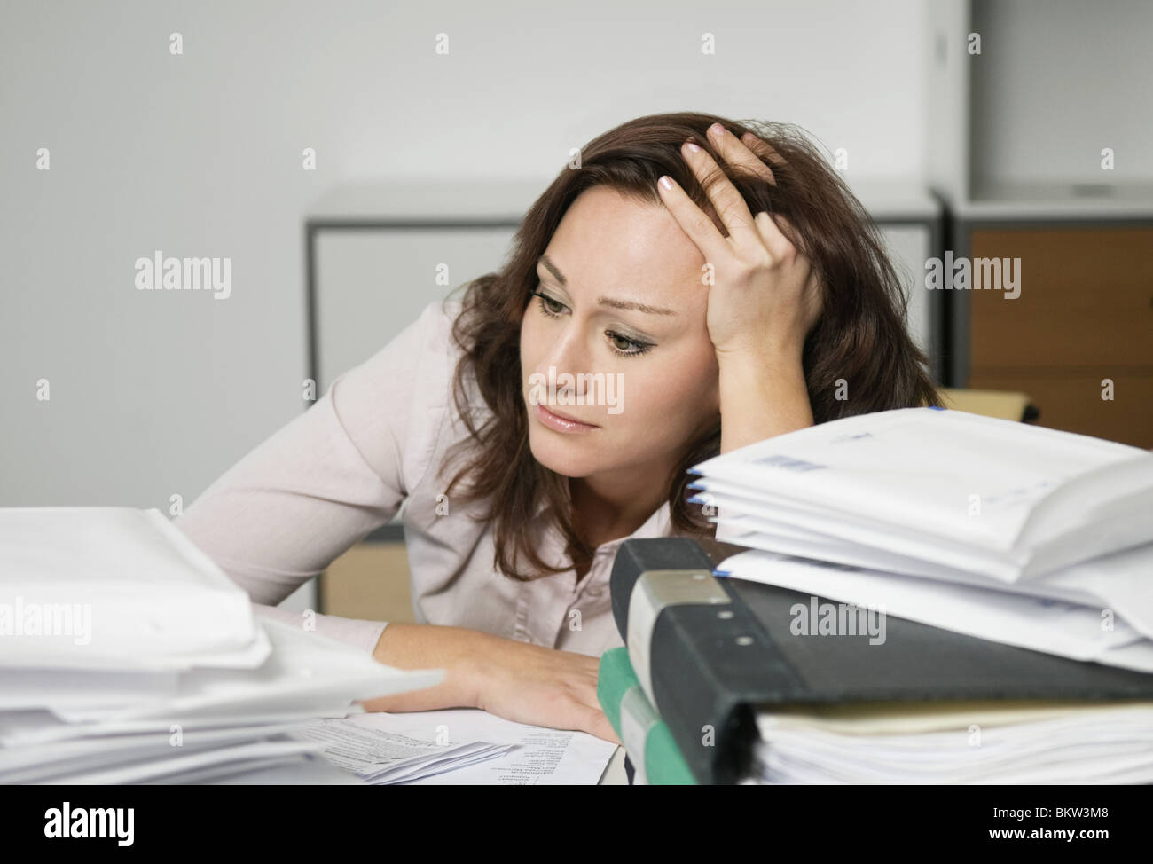 Resigned woman behind desk Stock Photo - Alamy