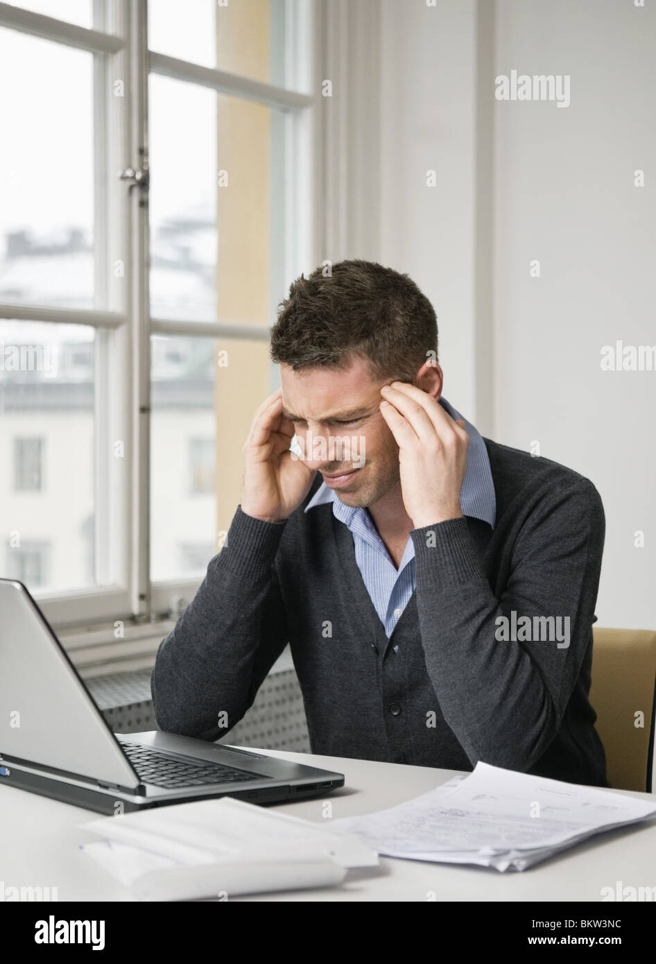 Troubled businessman using laptop Stock Photo - Alamy
