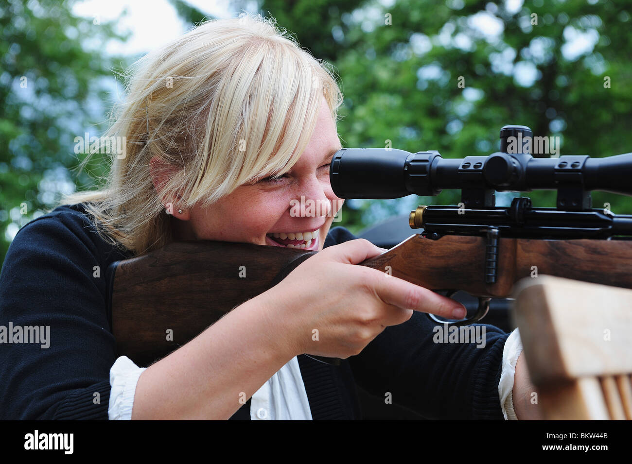 Woman with rifle Stock Photo - Alamy
