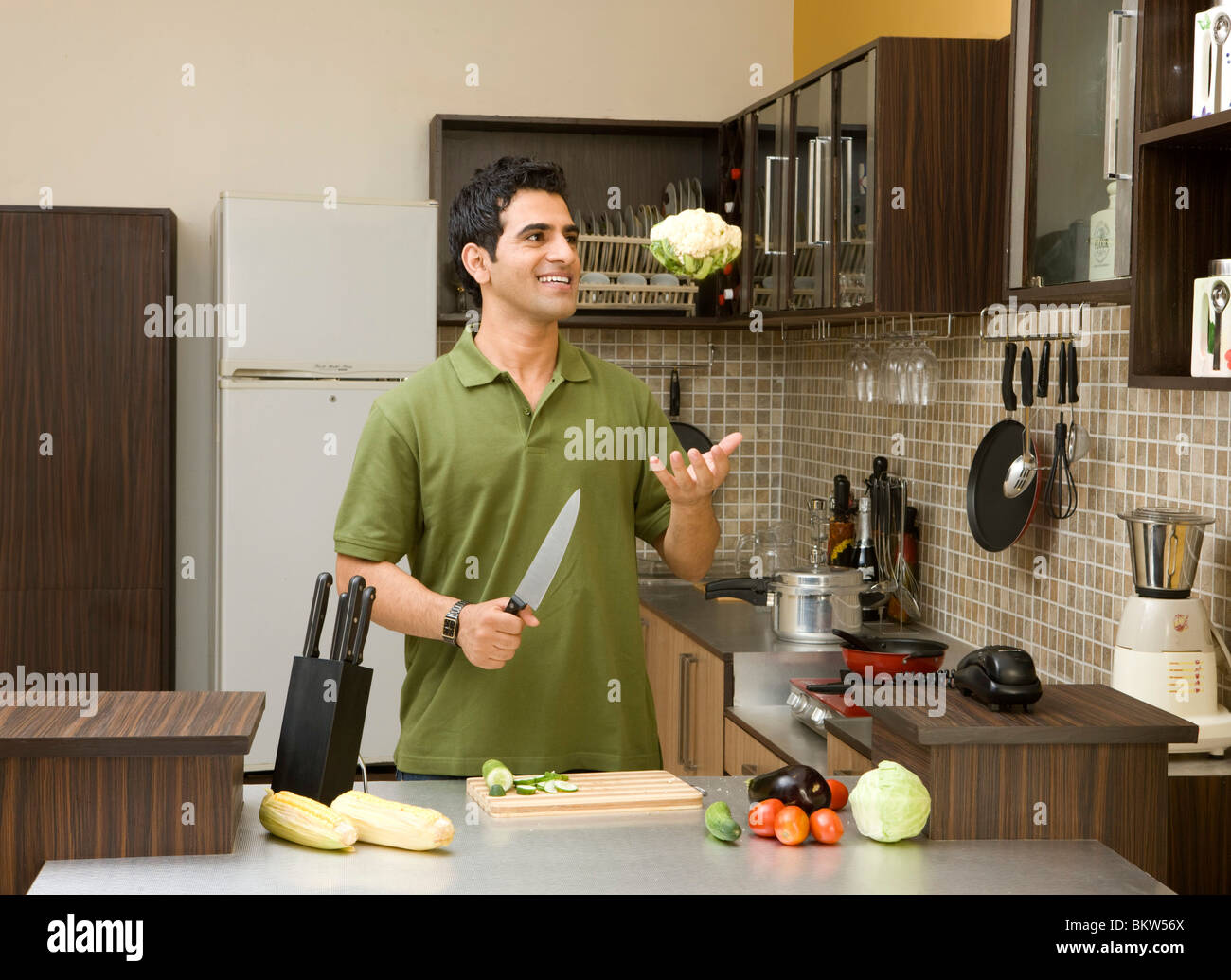 Man cutting vegetables in the kitchen Stock Photo - Alamy