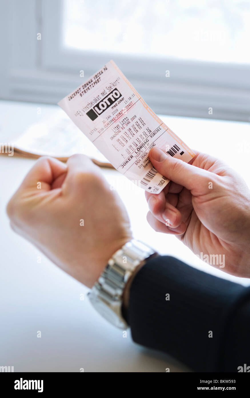 Man with lottery ticket Stock Photo - Alamy