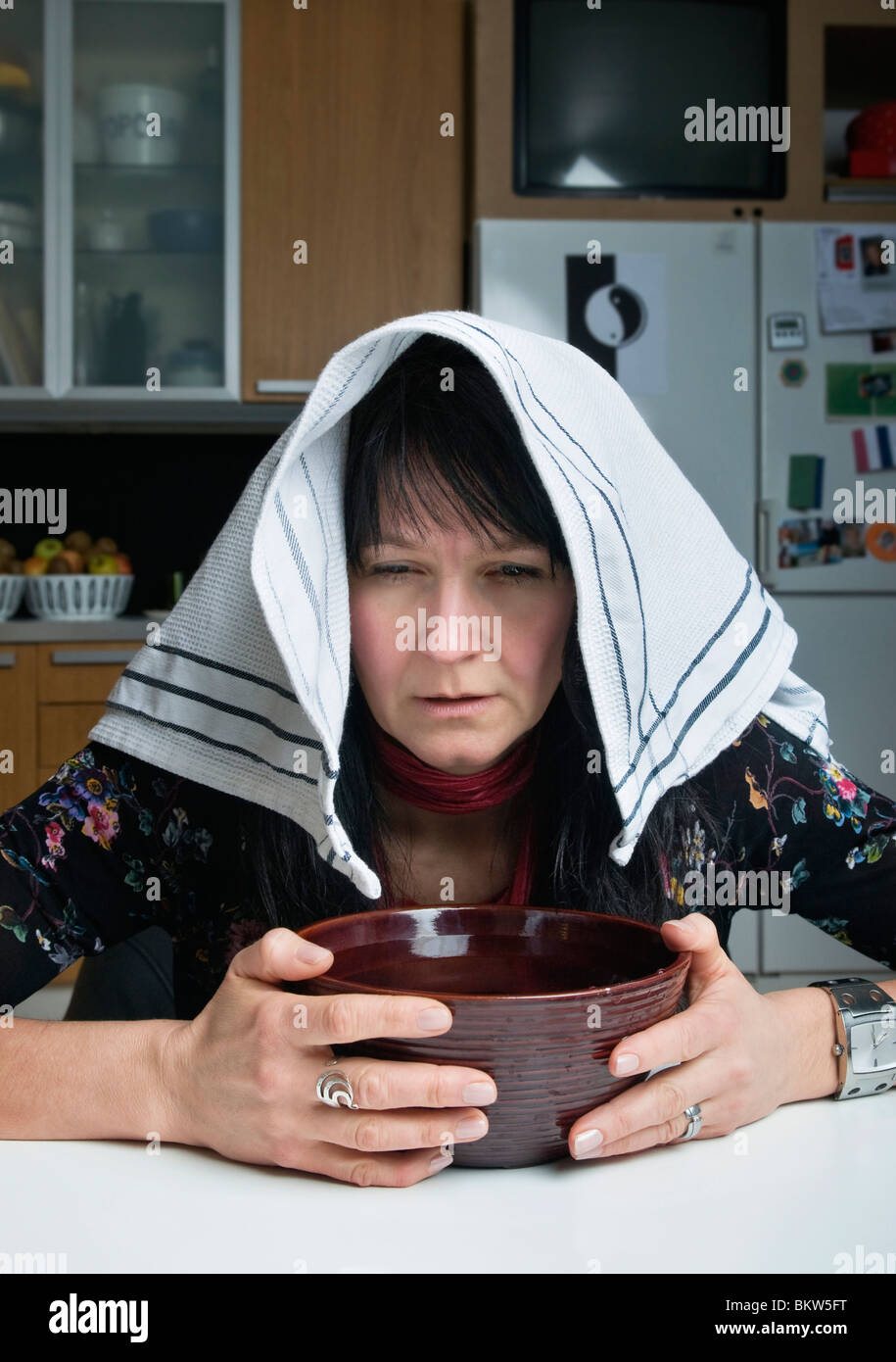 A sick woman sitting by table Stock Photo - Alamy