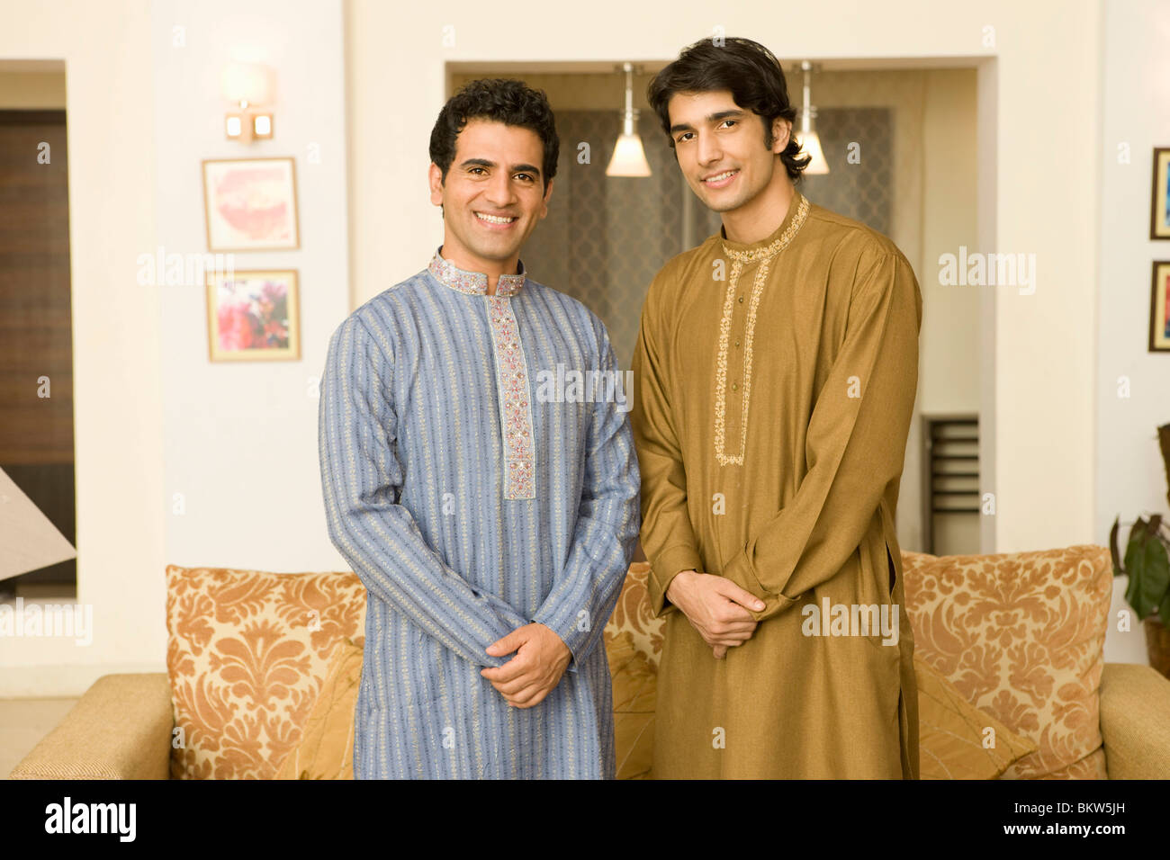 Two men wearing traditional clothes standing, smiling Stock Photo - Alamy