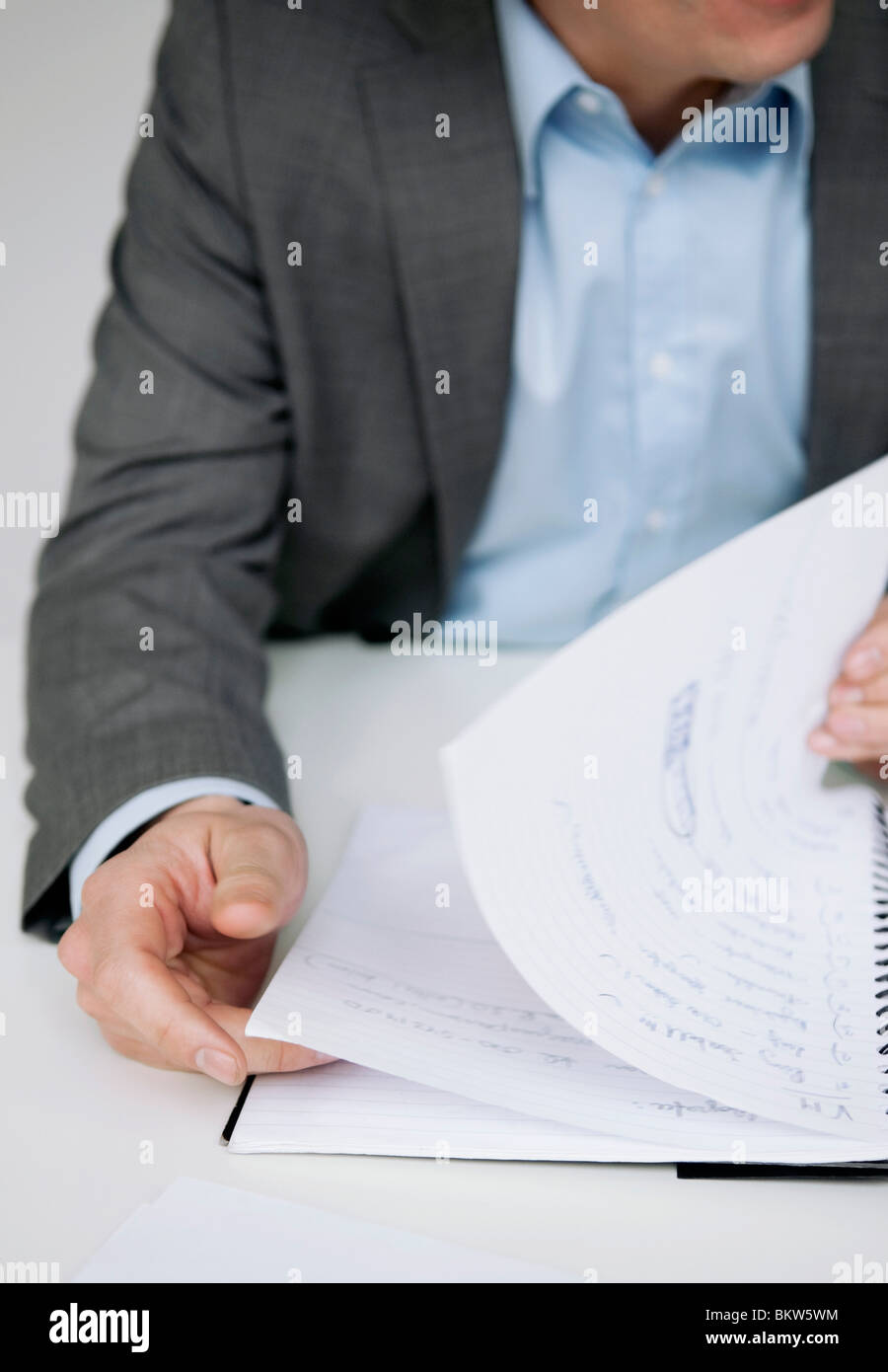 Man looking through papers Stock Photo - Alamy