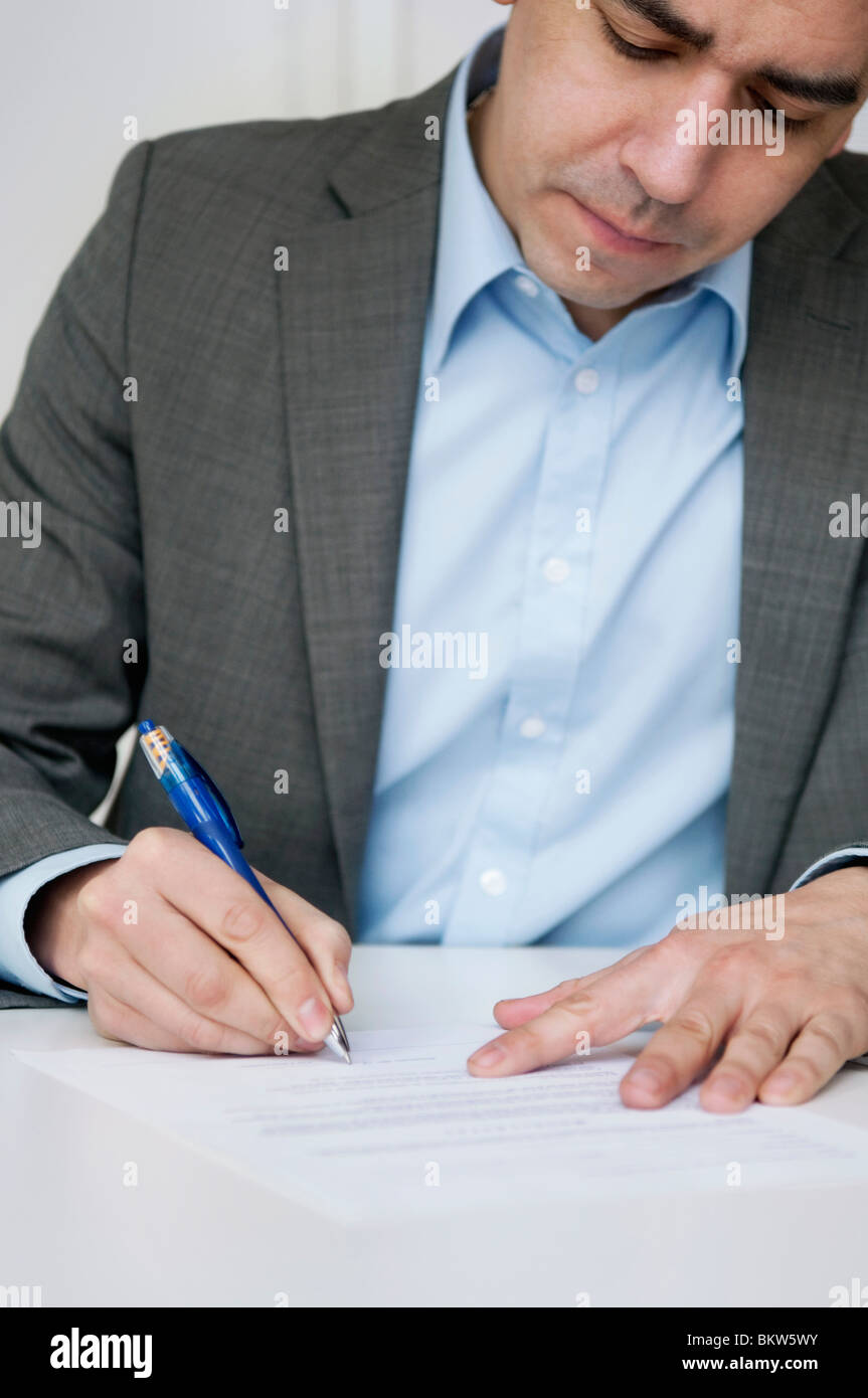 Signing his hi-res stock photography and images - Alamy