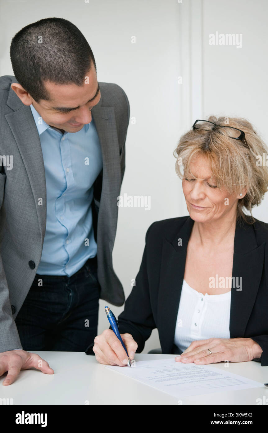 Two colleagues signing paper Stock Photo - Alamy Two colleagues signing paper Stock Photo - Alamy
