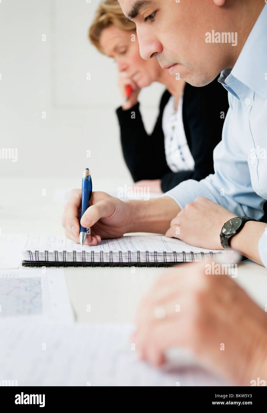 People taking notes Stock Photo - Alamy