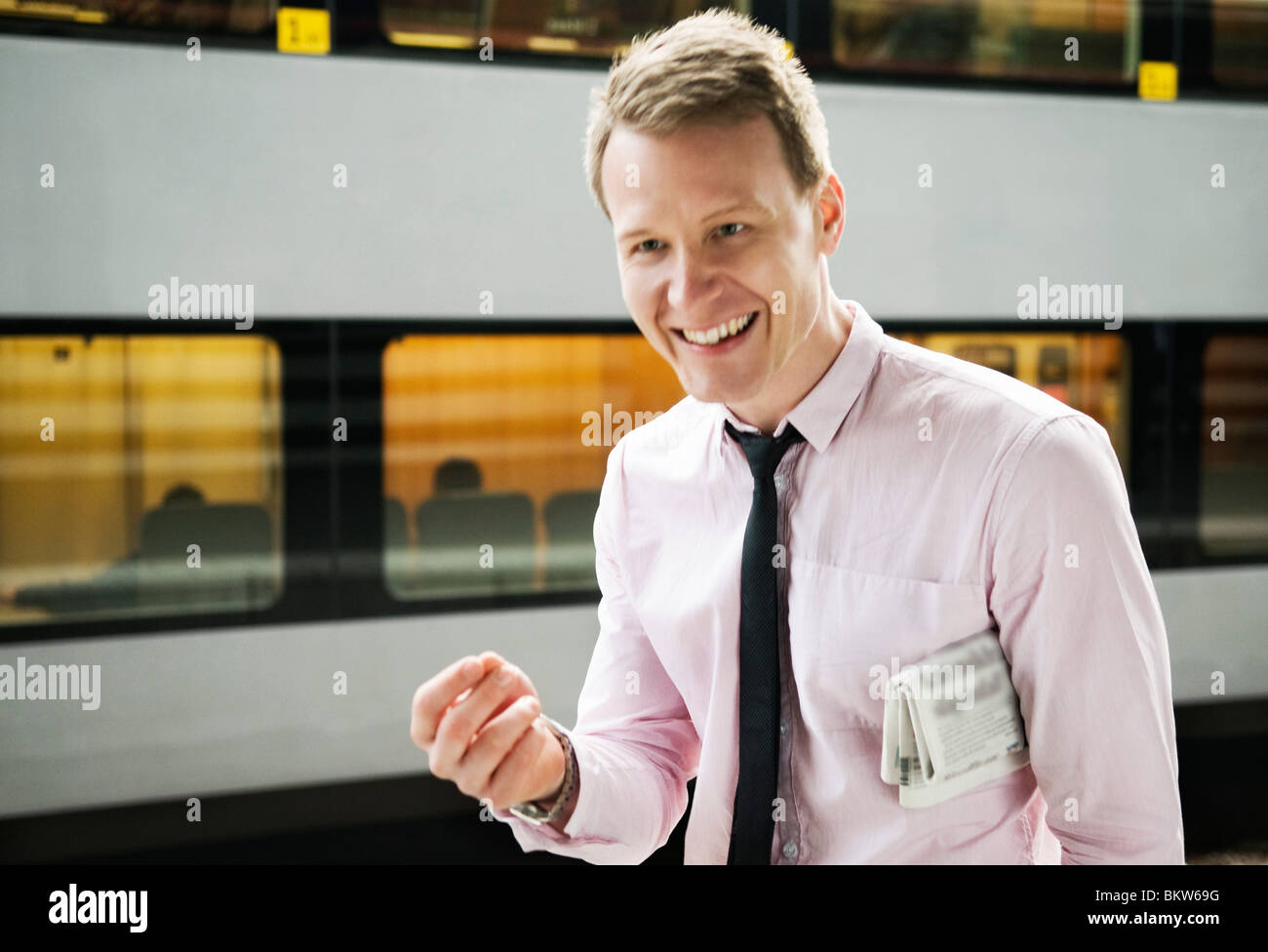 Happy man with newspaper Stock Photo - Alamy