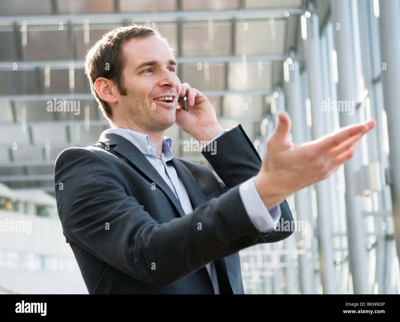 Man gesticulating with mobile phone in hand hi-res stock photography ...