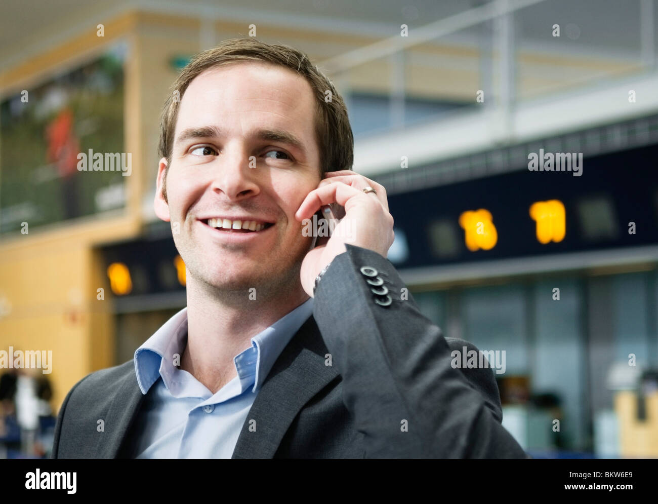 Man talking in phone at airport Stock Photo - Alamy