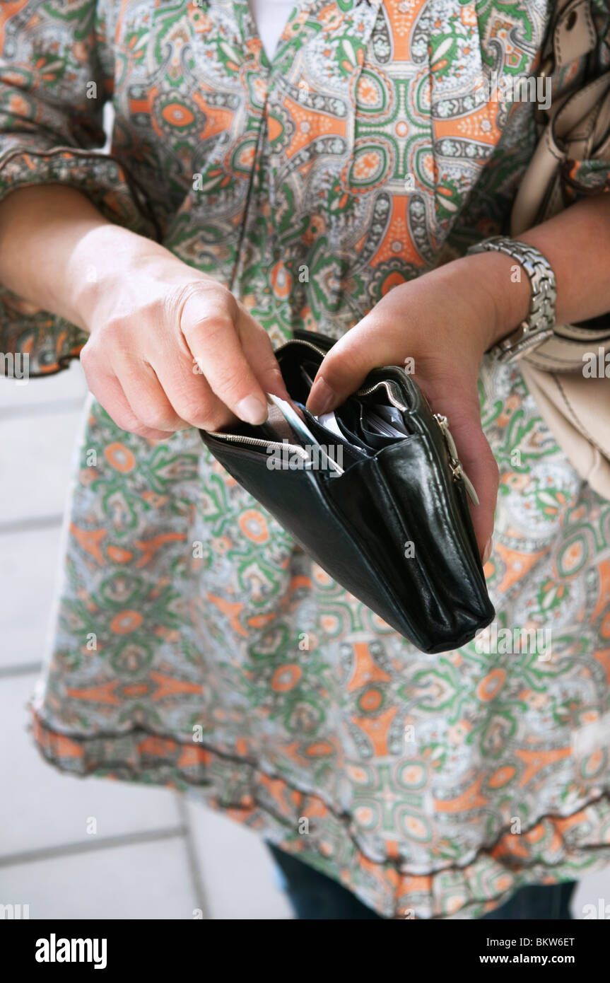 Woman holding wallet Stock Photo - Alamy