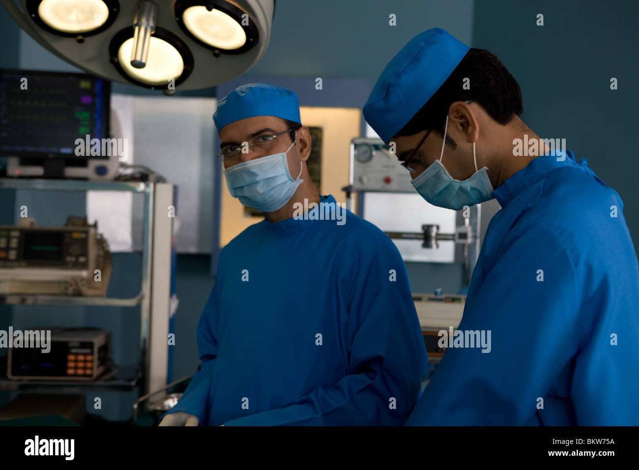 Two male surgeon inside the operating room Stock Photo - Alamy