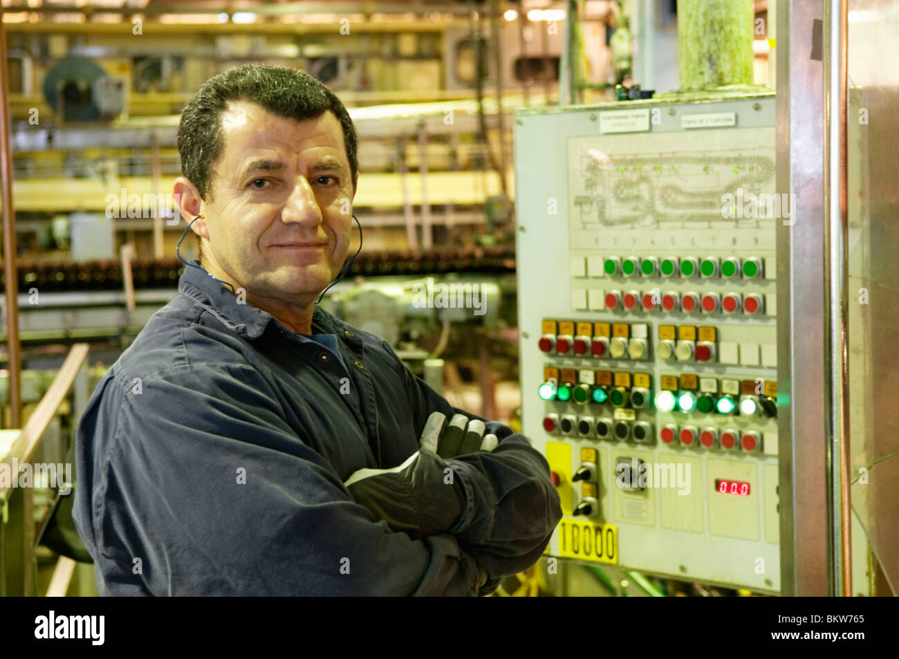 Man standing by control panel Stock Photo - Alamy