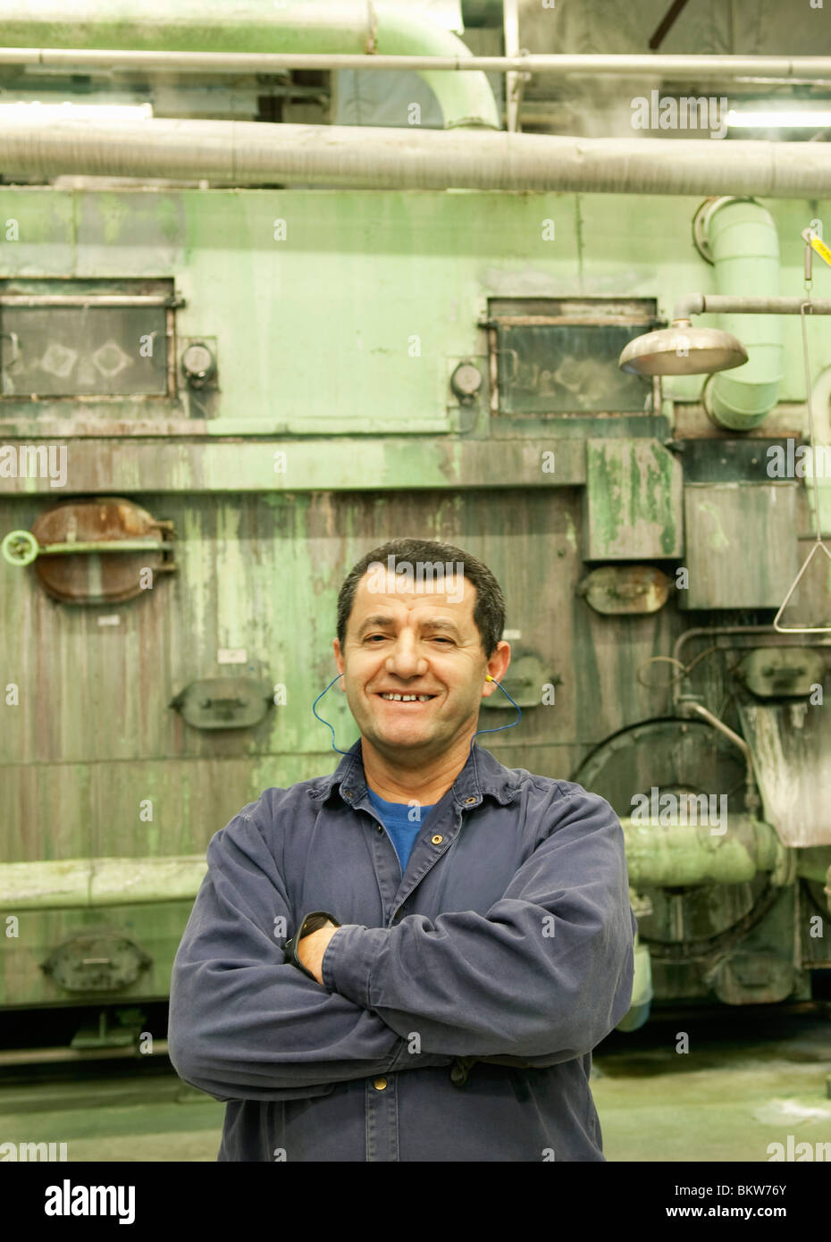 Man standing in machine hall Stock Photo - Alamy