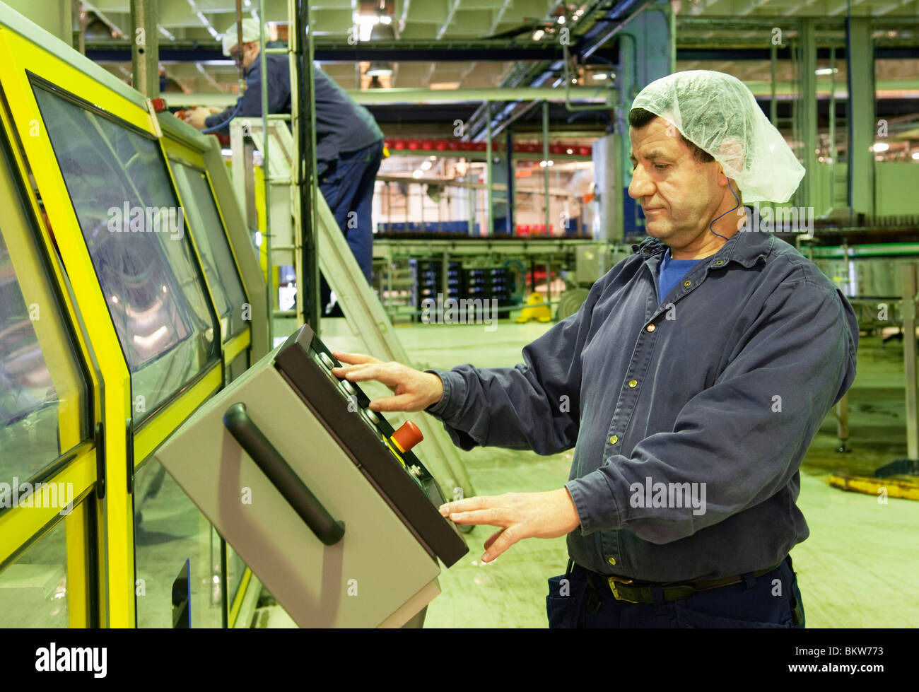 Two workers checking machine Stock Photo - Alamy
