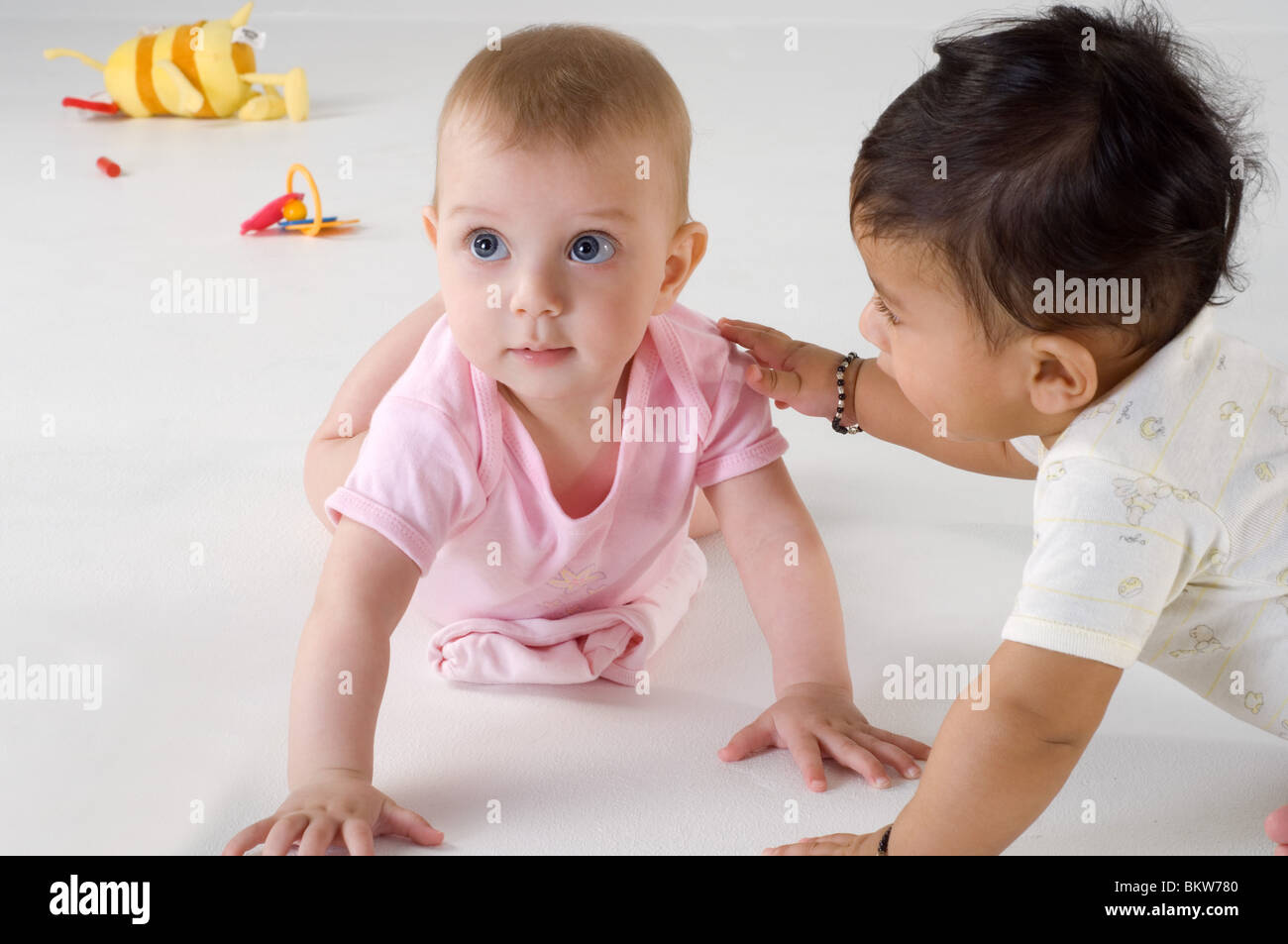 Two babies playing together Stock Photo - Alamy