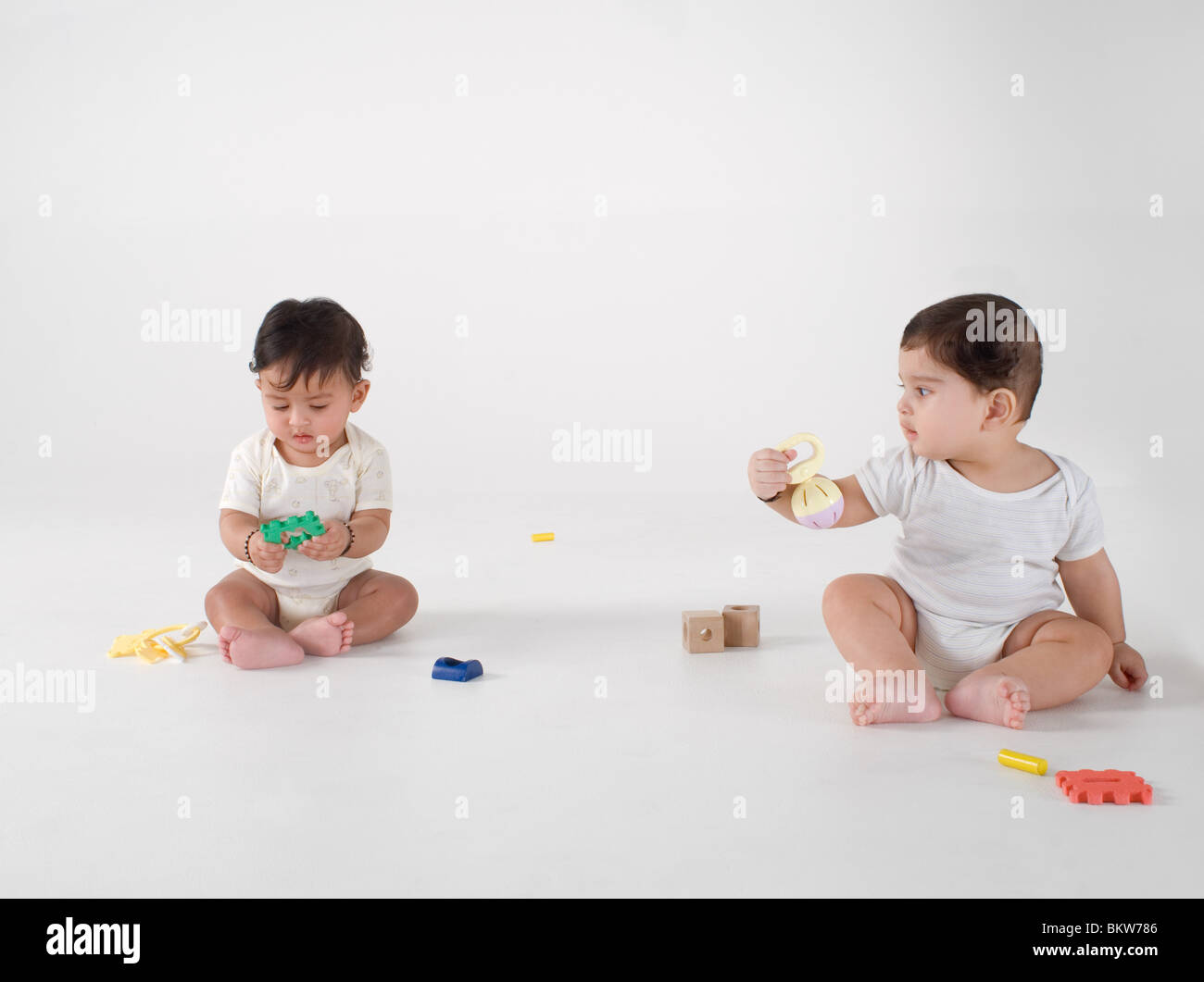 Two baby boy sitting together Stock Photo - Alamy