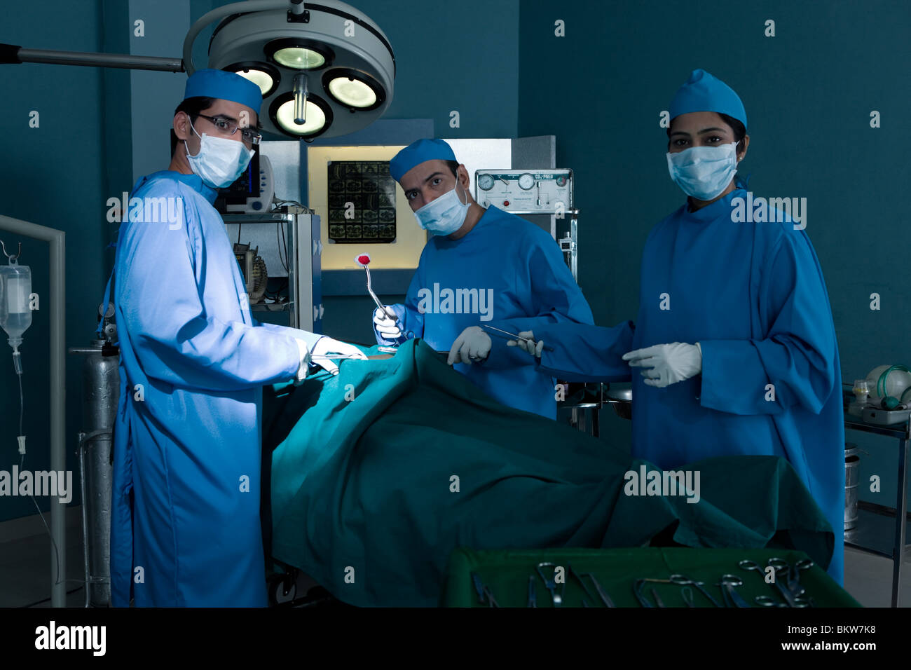 Surgical team doing an operation to a patient Stock Photo - Alamy