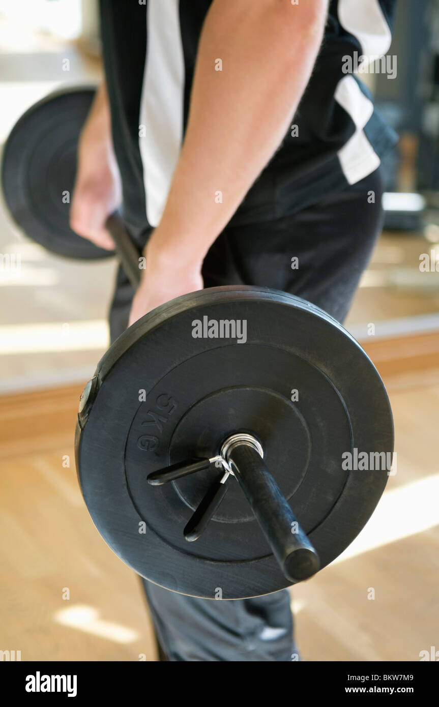 Guy lifting weights Stock Photo - Alamy