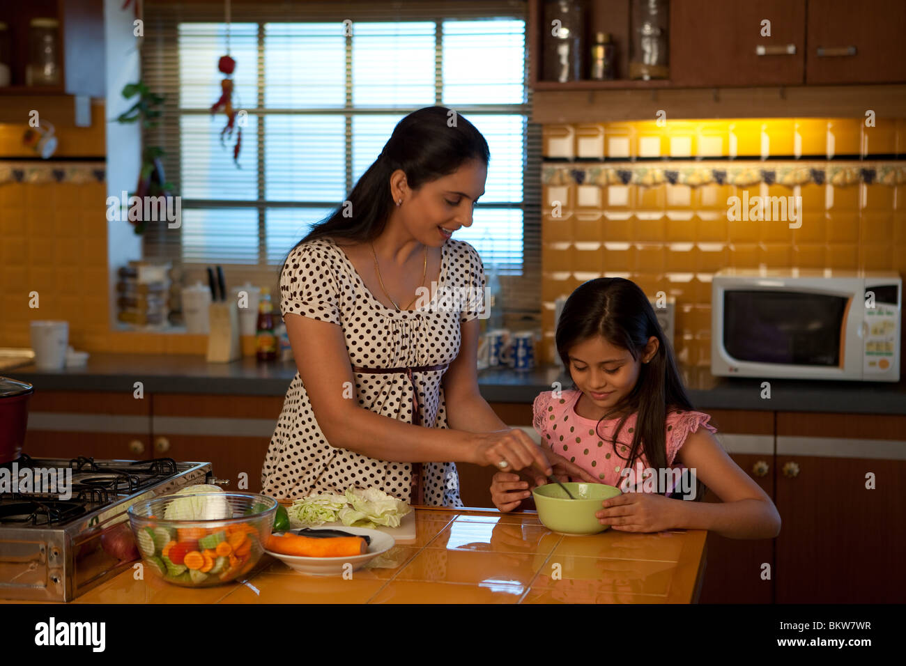 Mother and daughter cooking in the kitchen Stock Photo - Alamy