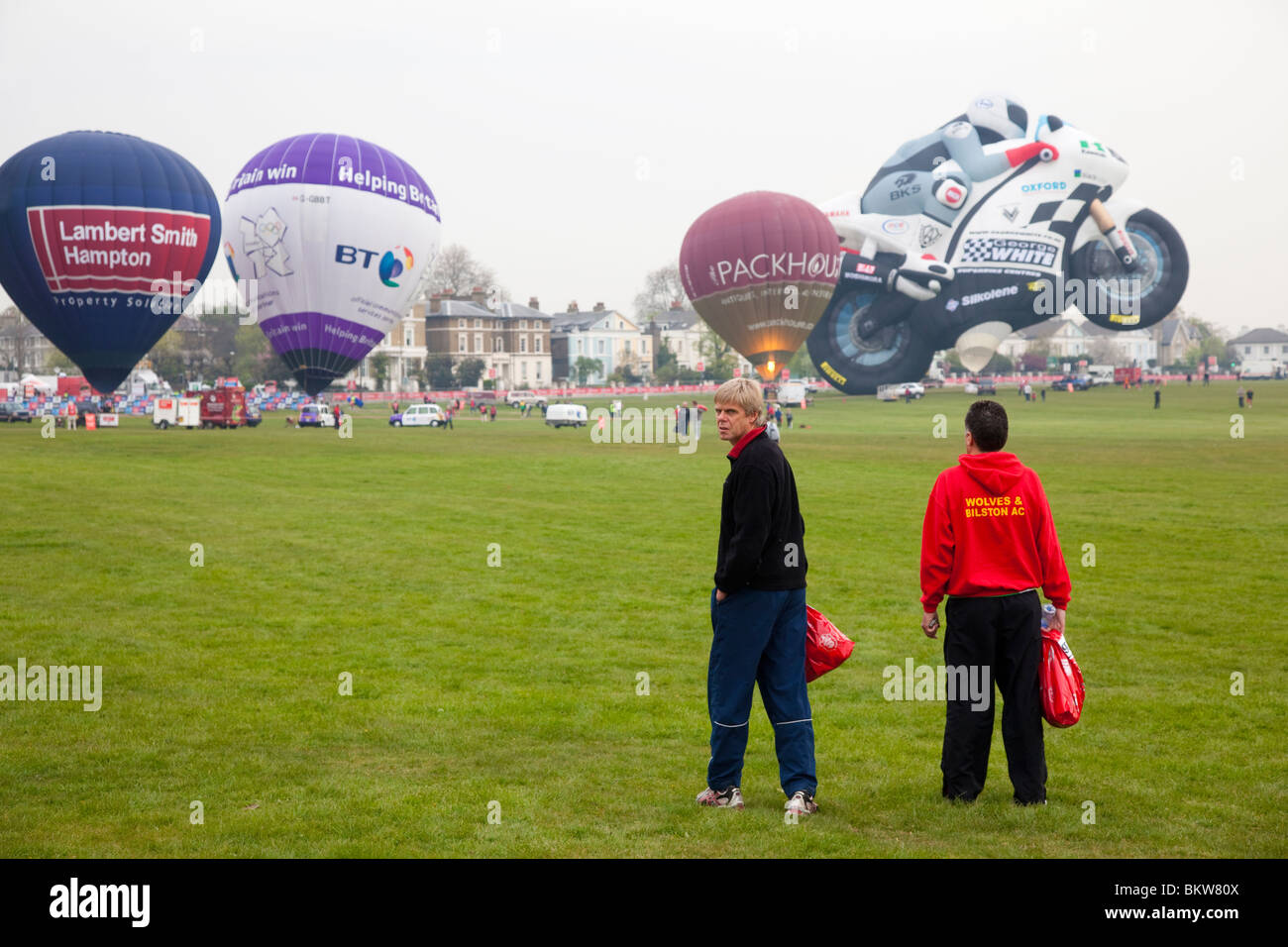 London Marathon 2010. Two runners look at the hot air balloons on ...