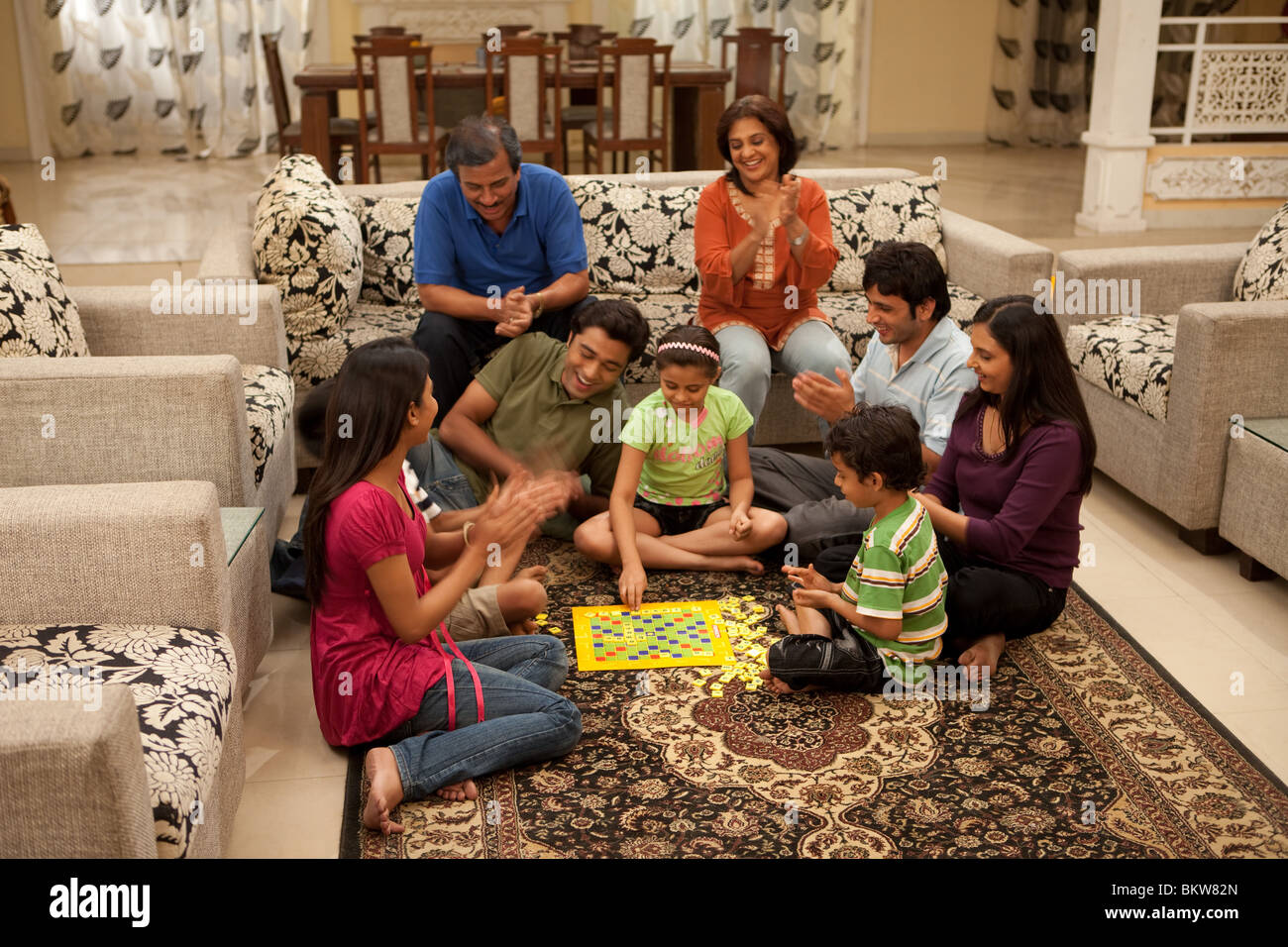 Three generation family playing scrabble in the living room Stock Photo ...