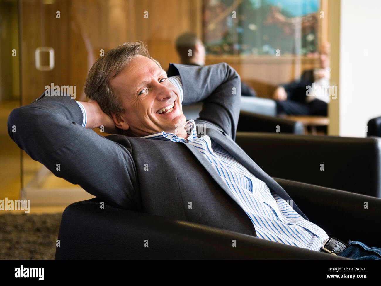 Man leaning back and relaxing Stock Photo - Alamy