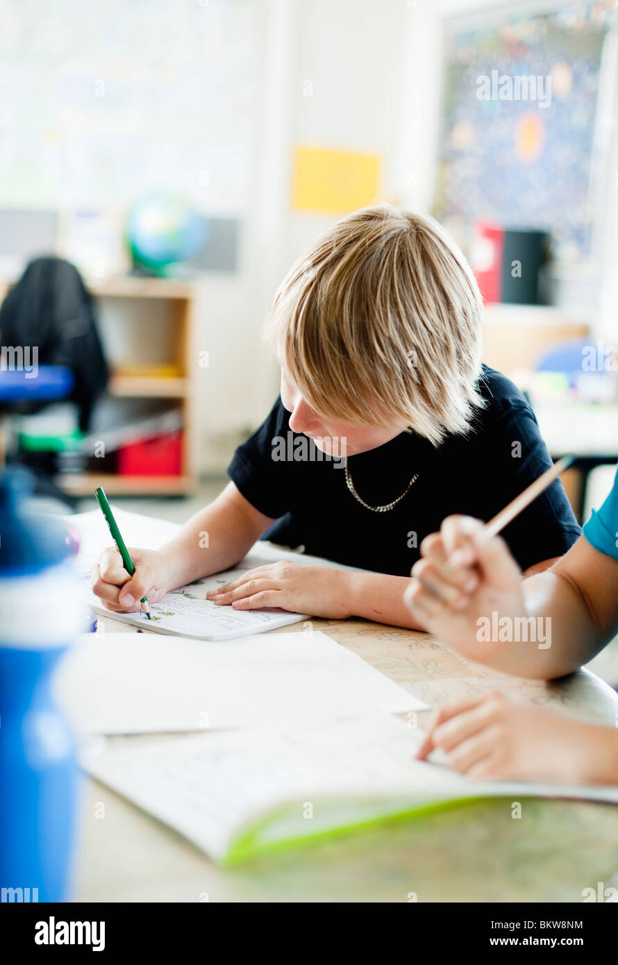 Boy writing on paper Stock Photo - Alamy