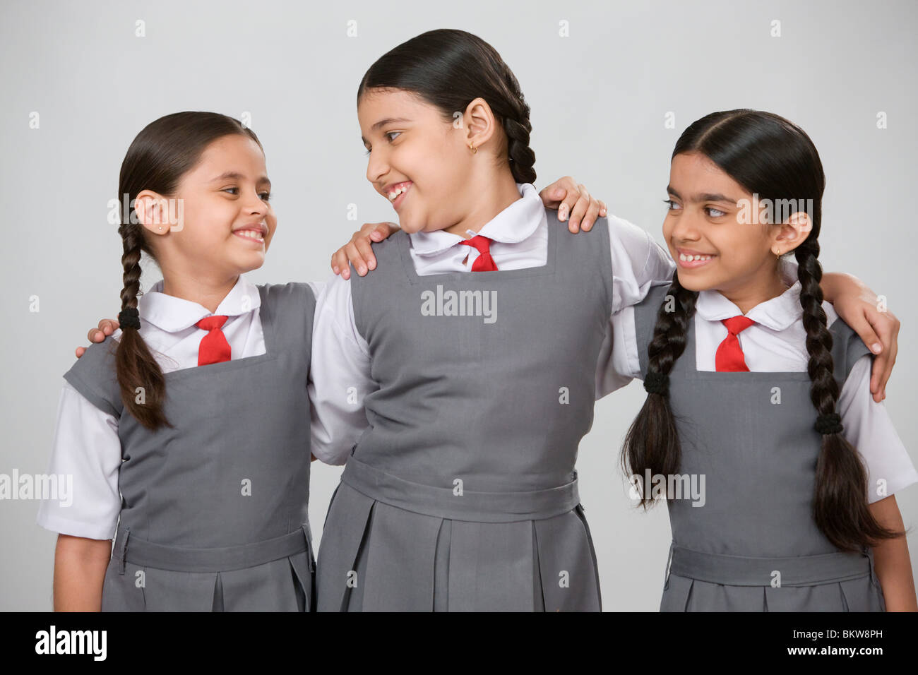 Three school girls laughing together Stock Photo - Alamy