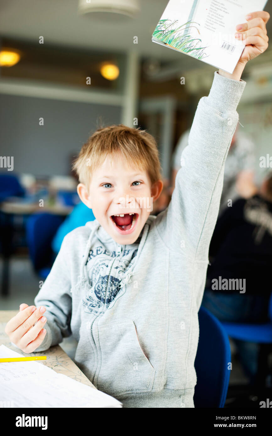 Happy pupils raising their hands class hi-res stock photography and ...