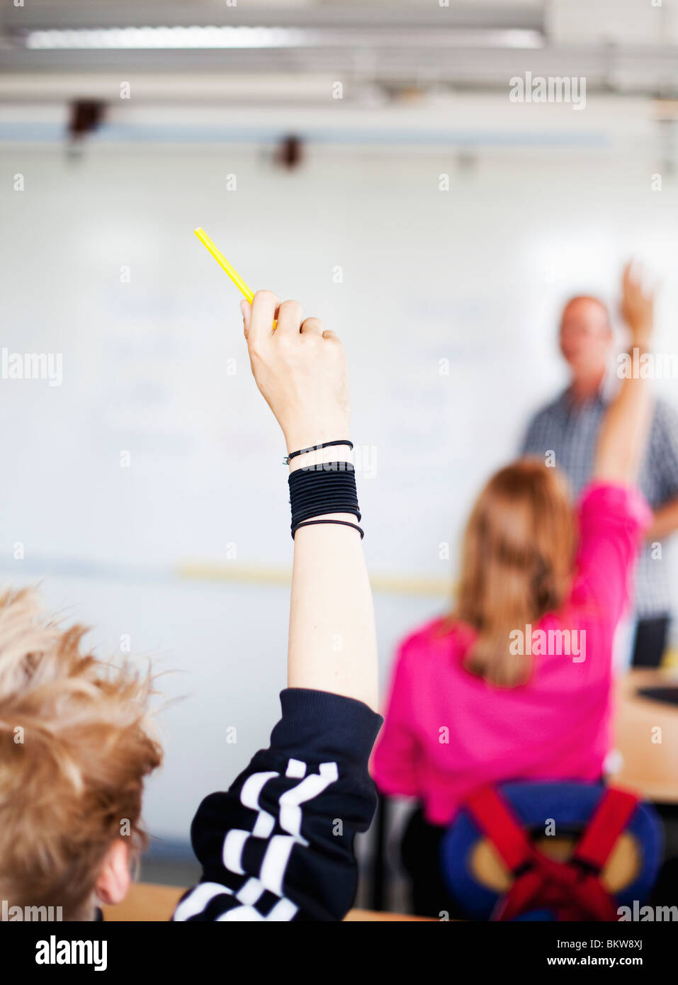 Middle school students raising hand hi-res stock photography and images ...