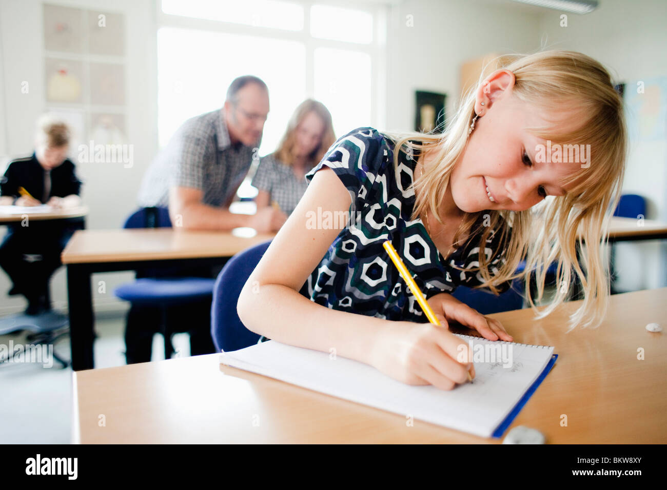 Girl 12 13 writing in notebook hi-res stock photography and images - Alamy