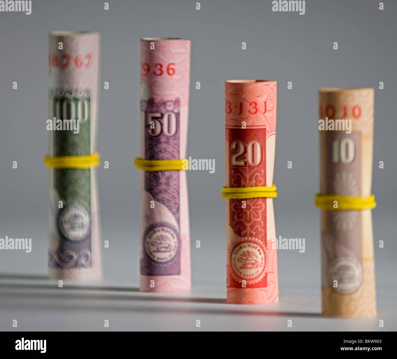 Different bank notes of Indian rupee currency rolled and lined up Stock ...