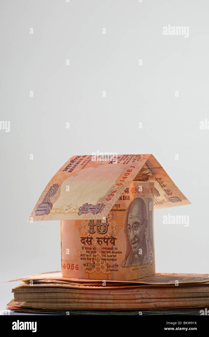 Indian rupee banknotes in a shape of house Stock Photo - Alamy