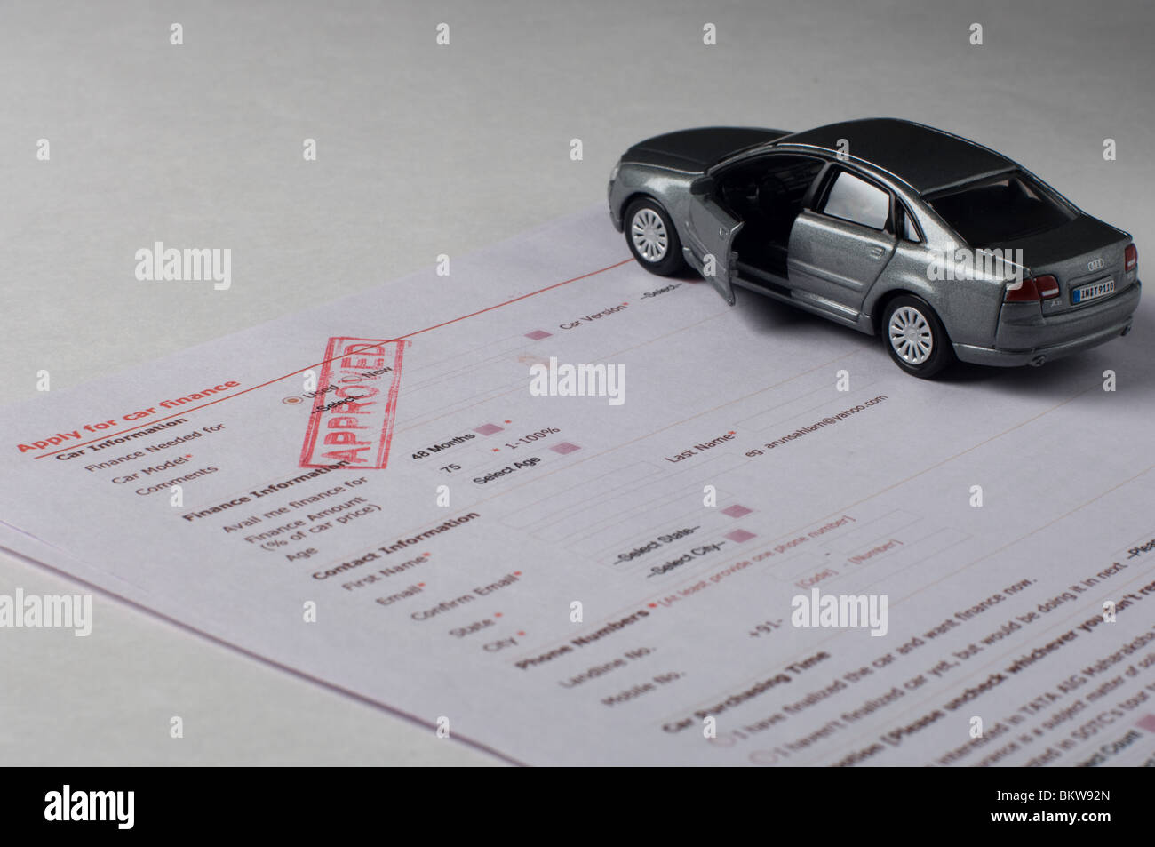 Toy car and application form Stock Photo - Alamy