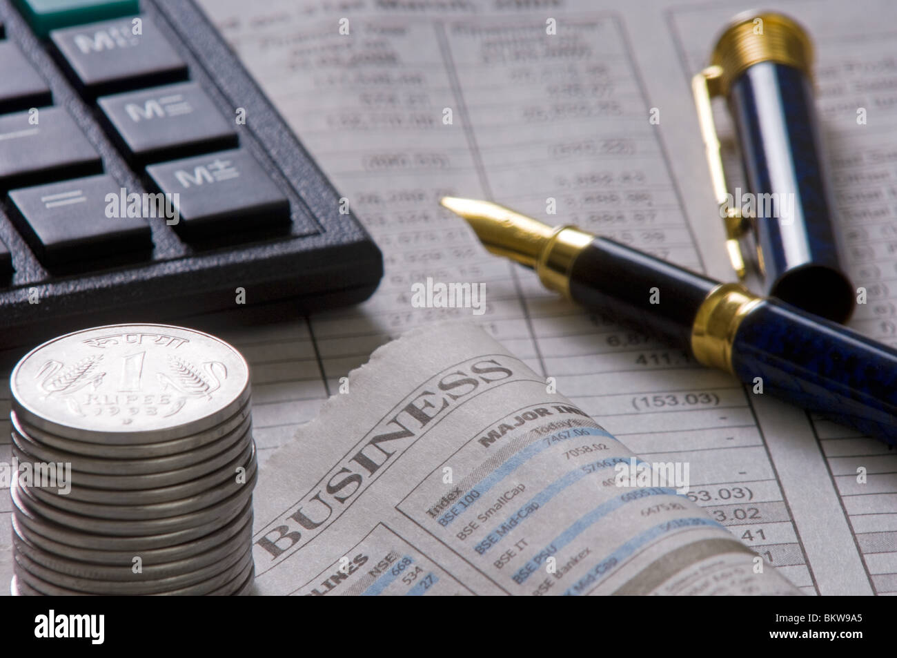Indian rupee coins on top of business section a newspaper Stock Photo ...
