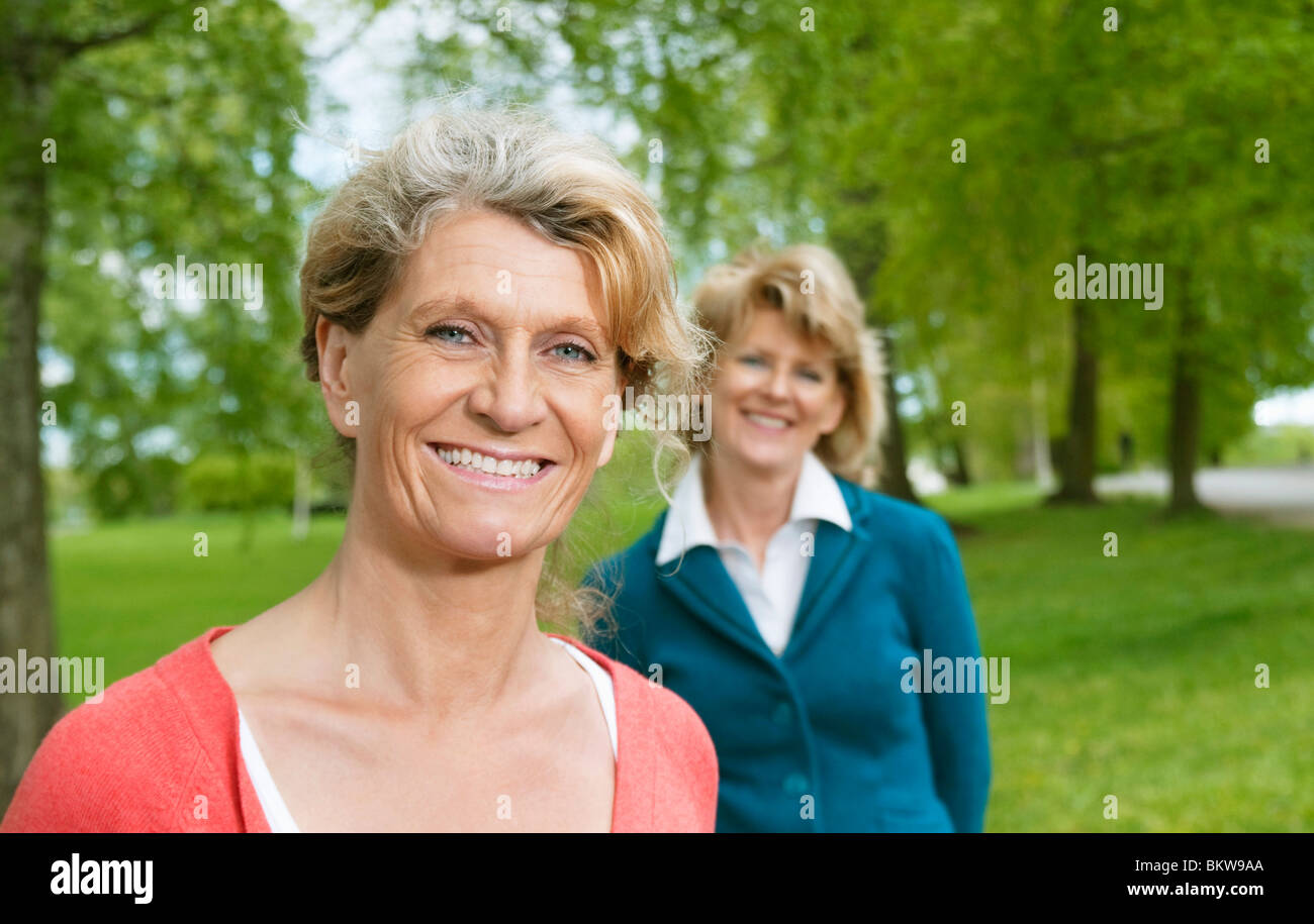 Two happy women in a park Stock Photo - Alamy