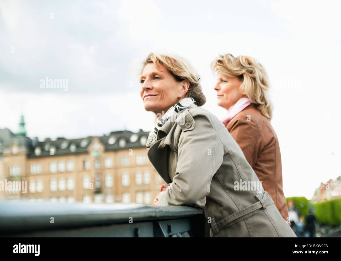 Woman leaning against rail hi-res stock photography and images - Alamy