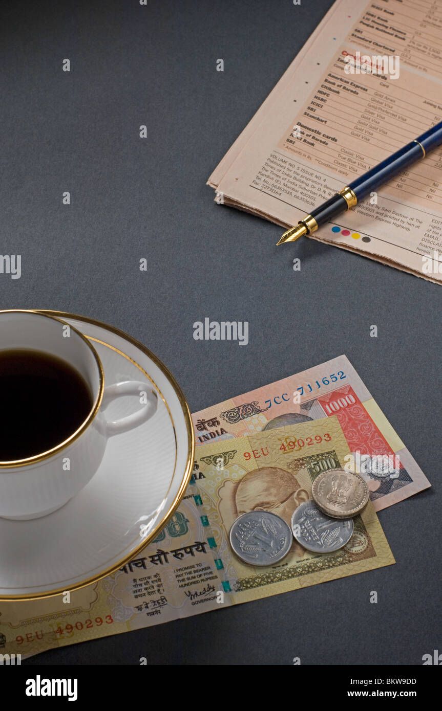 Coffee with indian rupees and financial section of newspaper Stock ...